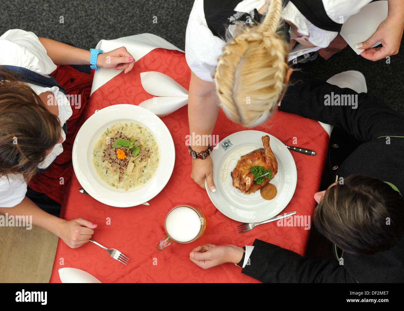 Waitress Corinna Spitzer (top) serves a dish of vegan chicken fricassee ...