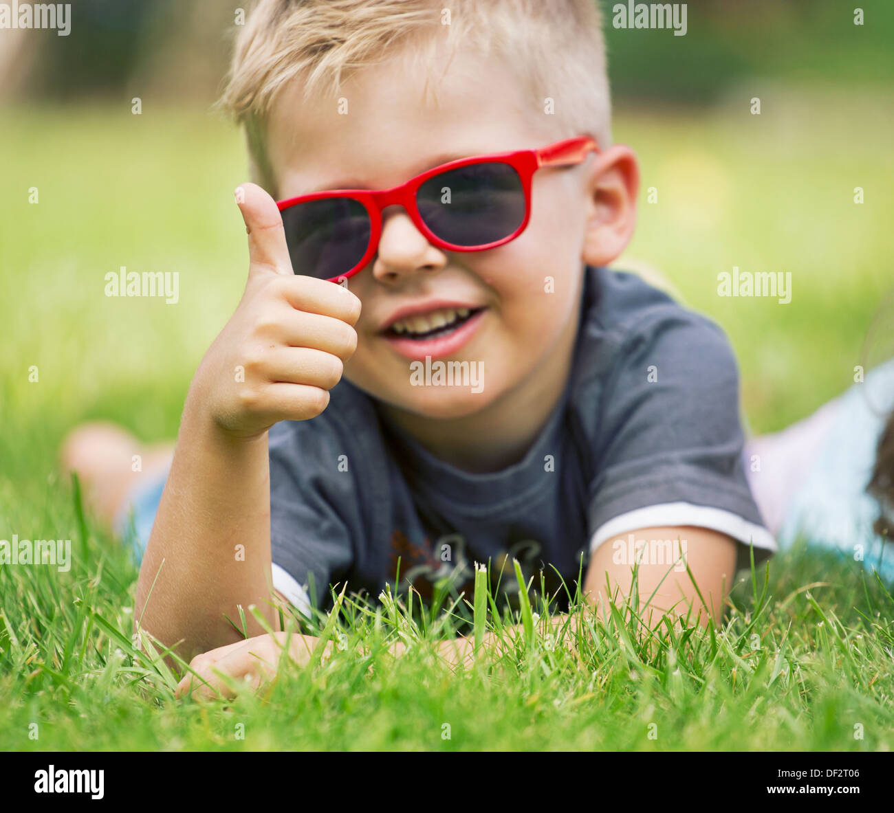 Portrait of smiling boy showing thumbs up gesture Stock Photo - Alamy