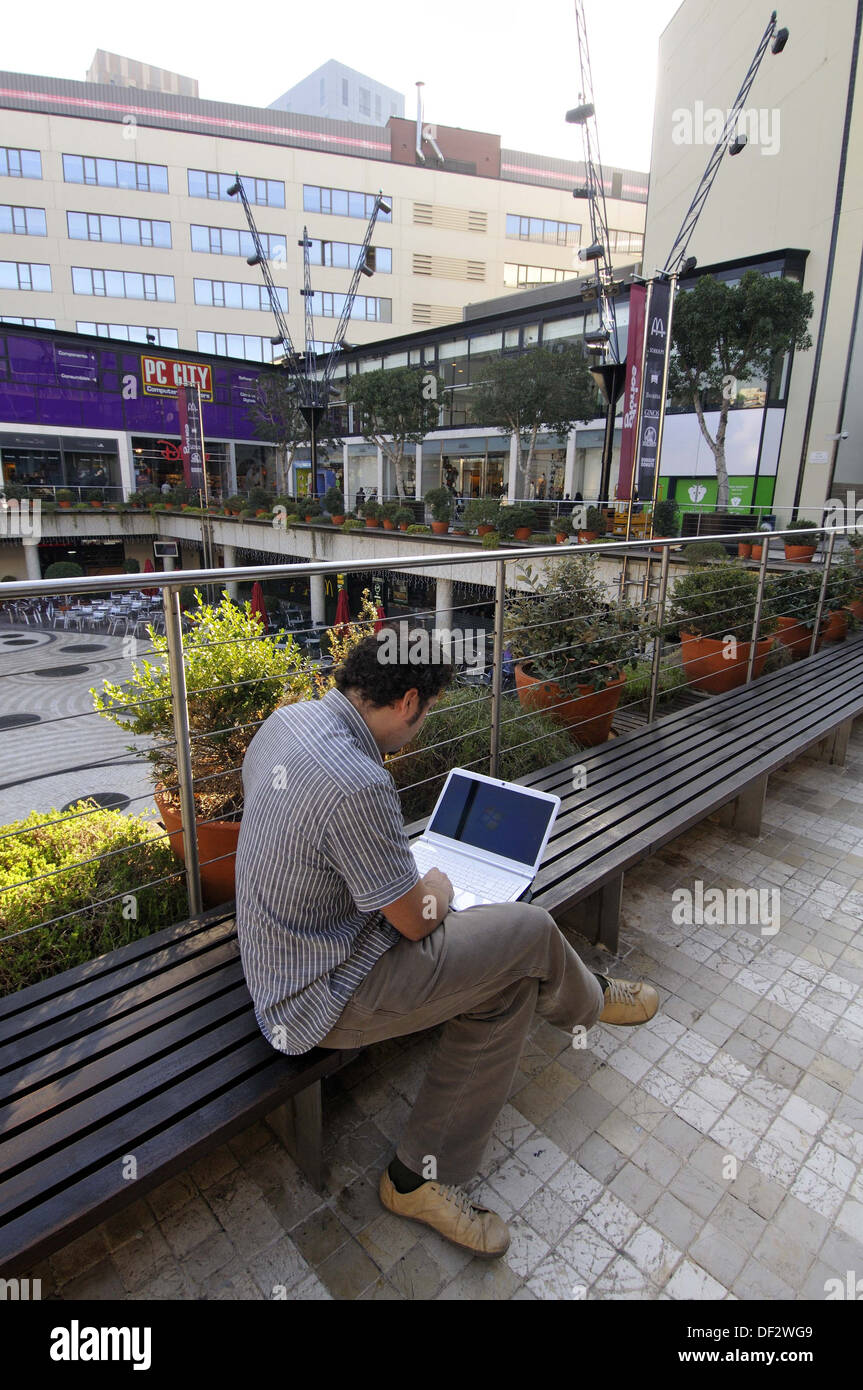 Man working with computer at Glories shopping mall, Barcelona ...