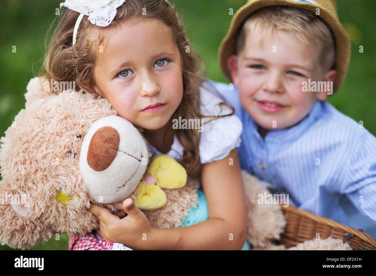 Glad kids holding cute teddy bear toy Stock Photo - Alamy