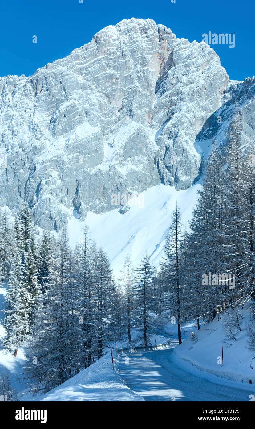 Winter rock with fresh fallen snow on top and and alpine road Stock ...