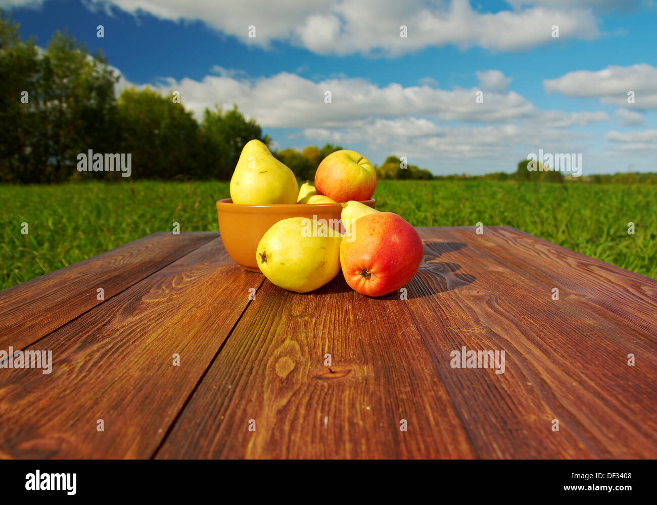 fruit on a wooden table.Background blue sky.Outdoor farm-style Stock ...