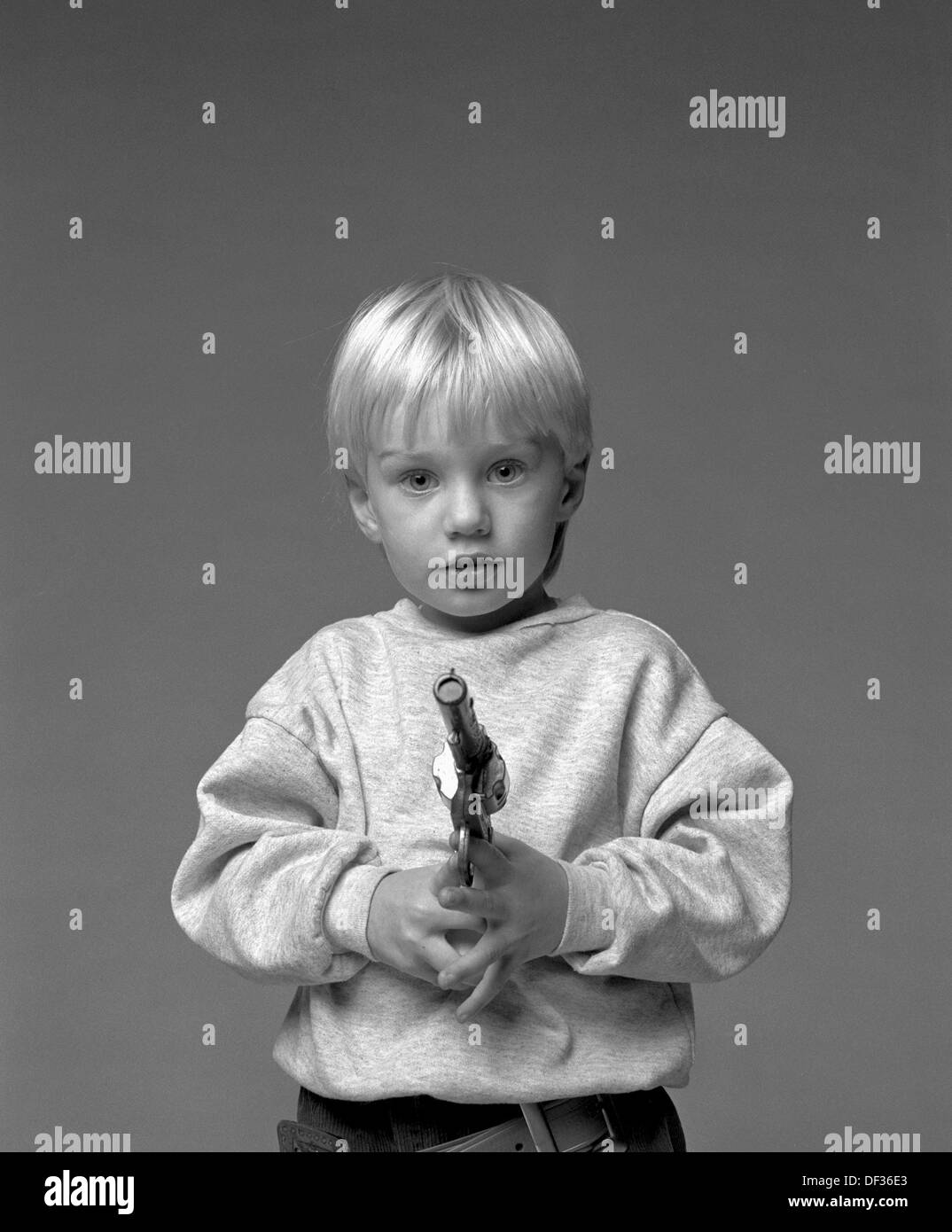 Child playing with toy gun Black and White Stock Photos & Images - Alamy
