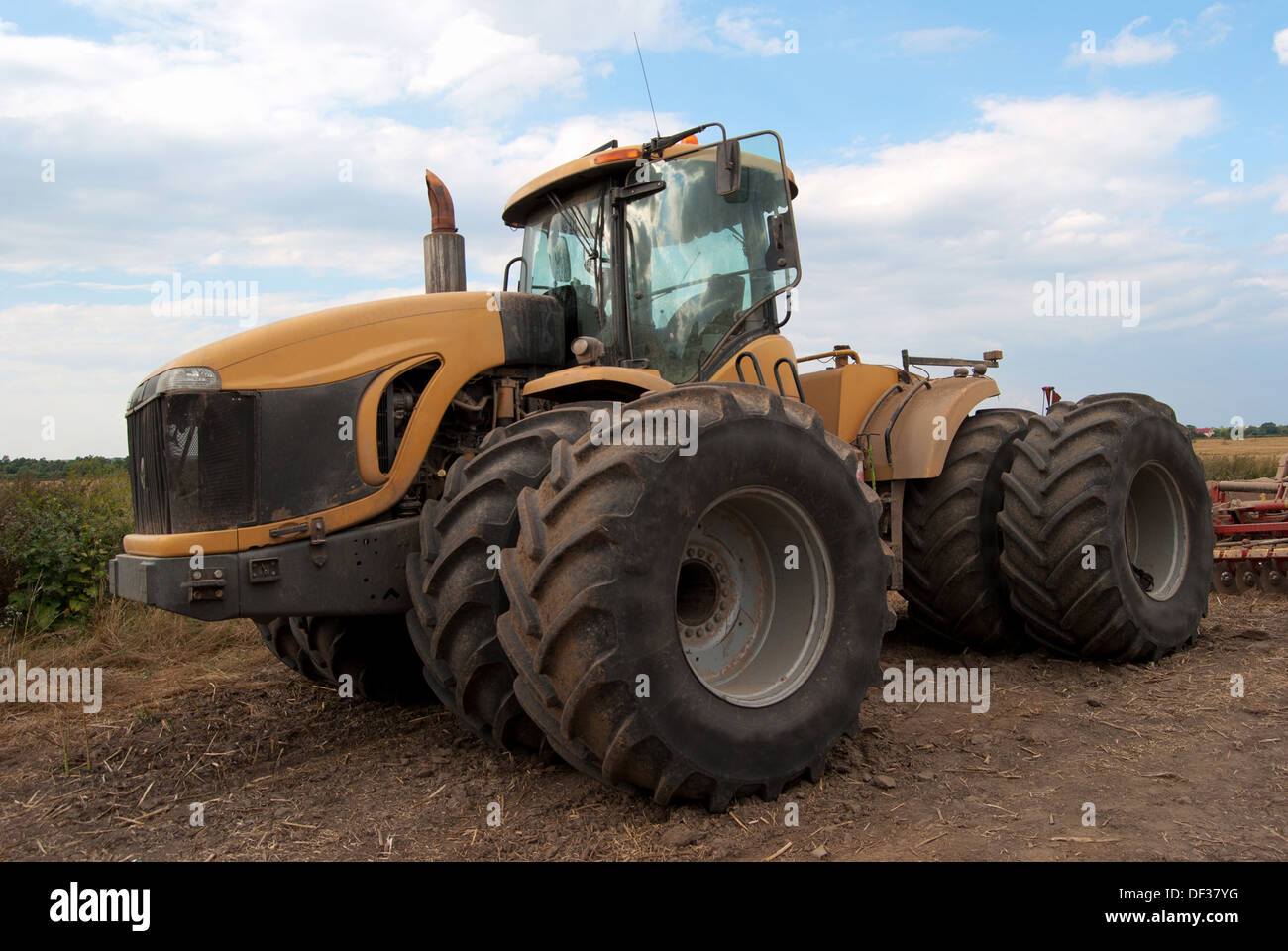 yellow tractor in autumn on field Stock Photo - Alamy