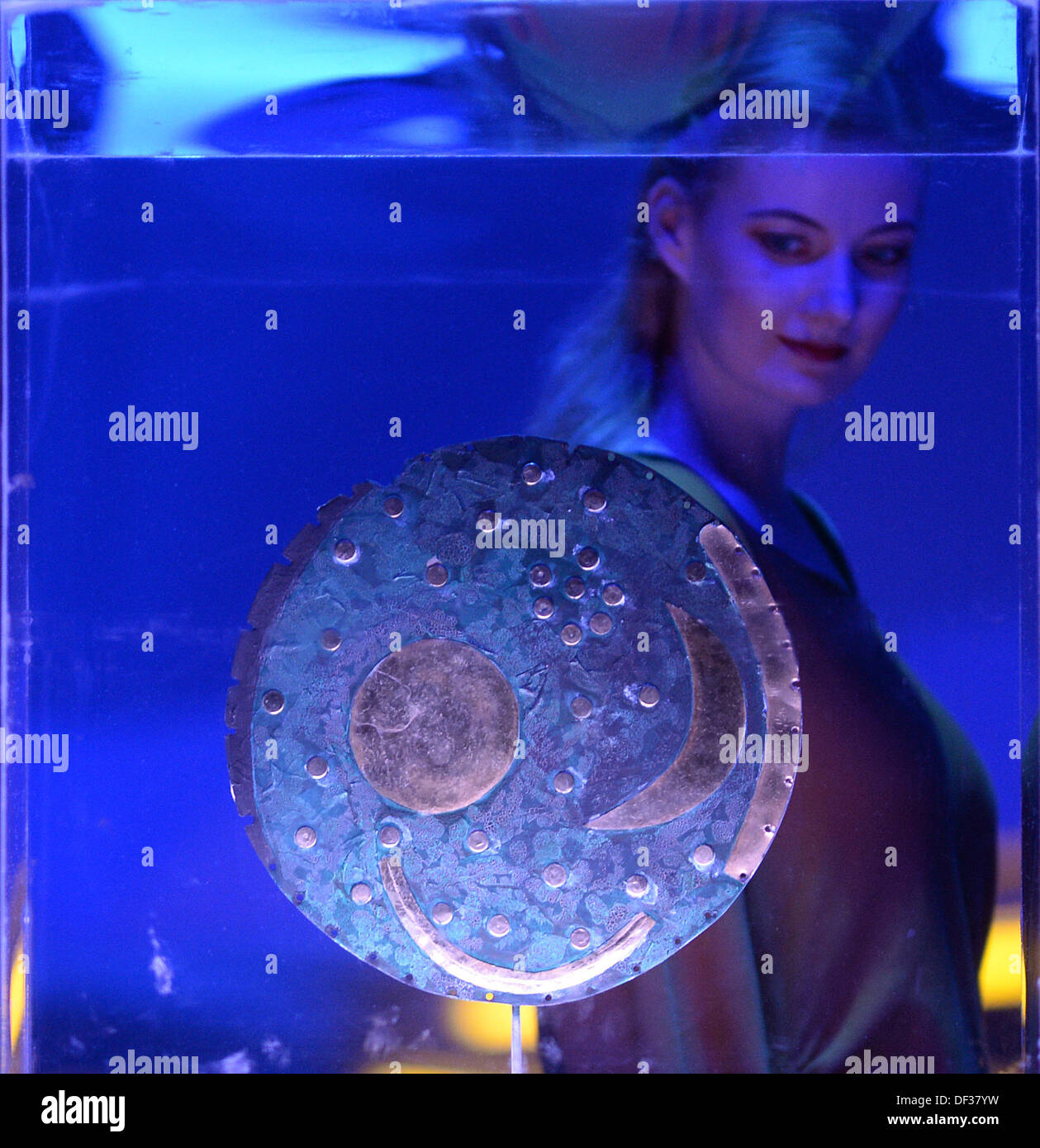 Opera singer Sandra Maxheimer walks past a replica of the Nebra sky ...