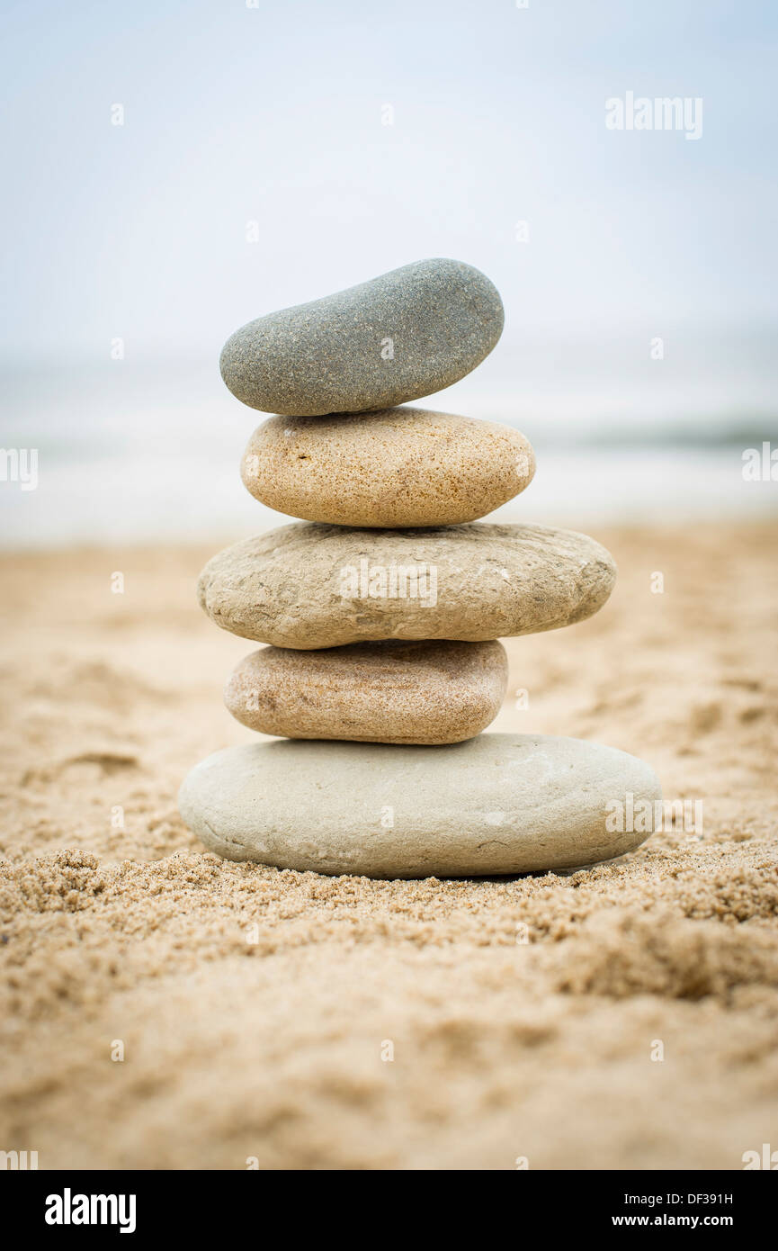 Five stones balanced on top of each other on a sandy beach Stock Photo ...