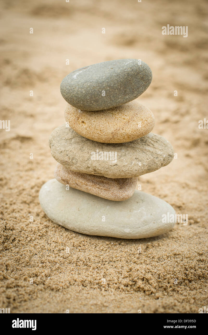 Five stones balanced on top of each other on a sandy beach Stock Photo ...