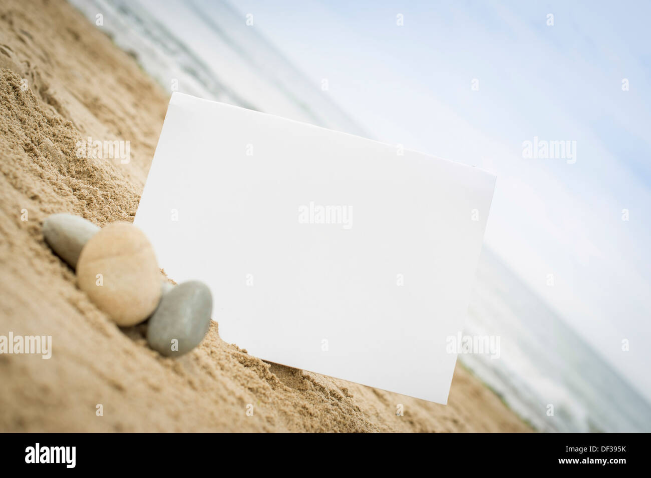 Blank white sign on a sand beach with stones and pebbles Stock Photo ...
