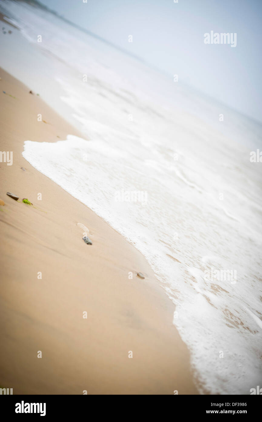 Tide coming in along a sand beach Stock Photo - Alamy