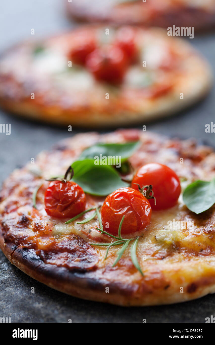 small pizzas with ham, bacon, cheese and tomatoes Stock Photo - Alamy