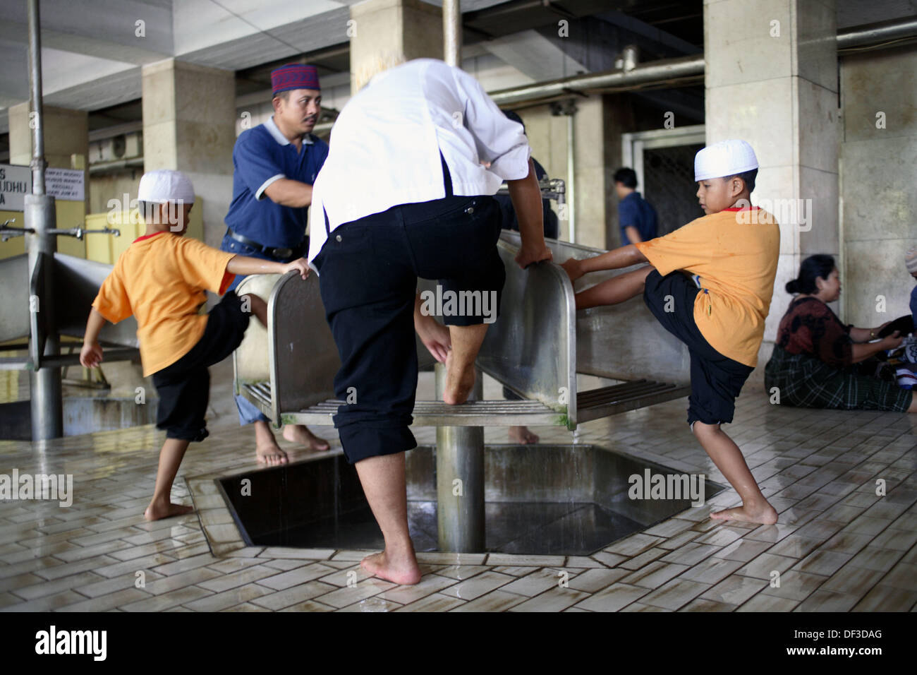 Moslems at the ritual cleaning ceremony before praying, Istiqlal mosque ...
