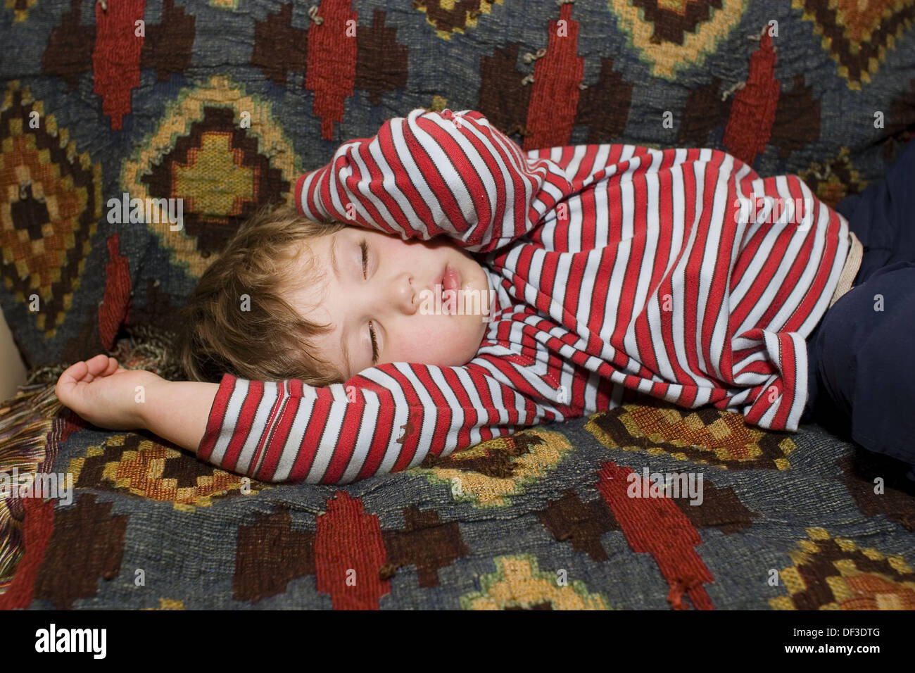 Three year old boy sleeping on a couch Stock Photo - Alamy