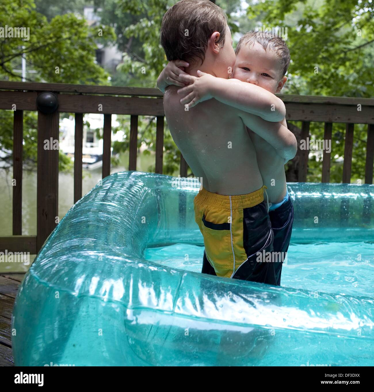 Two brothers swimming in pool hi-res stock photography and images - Alamy