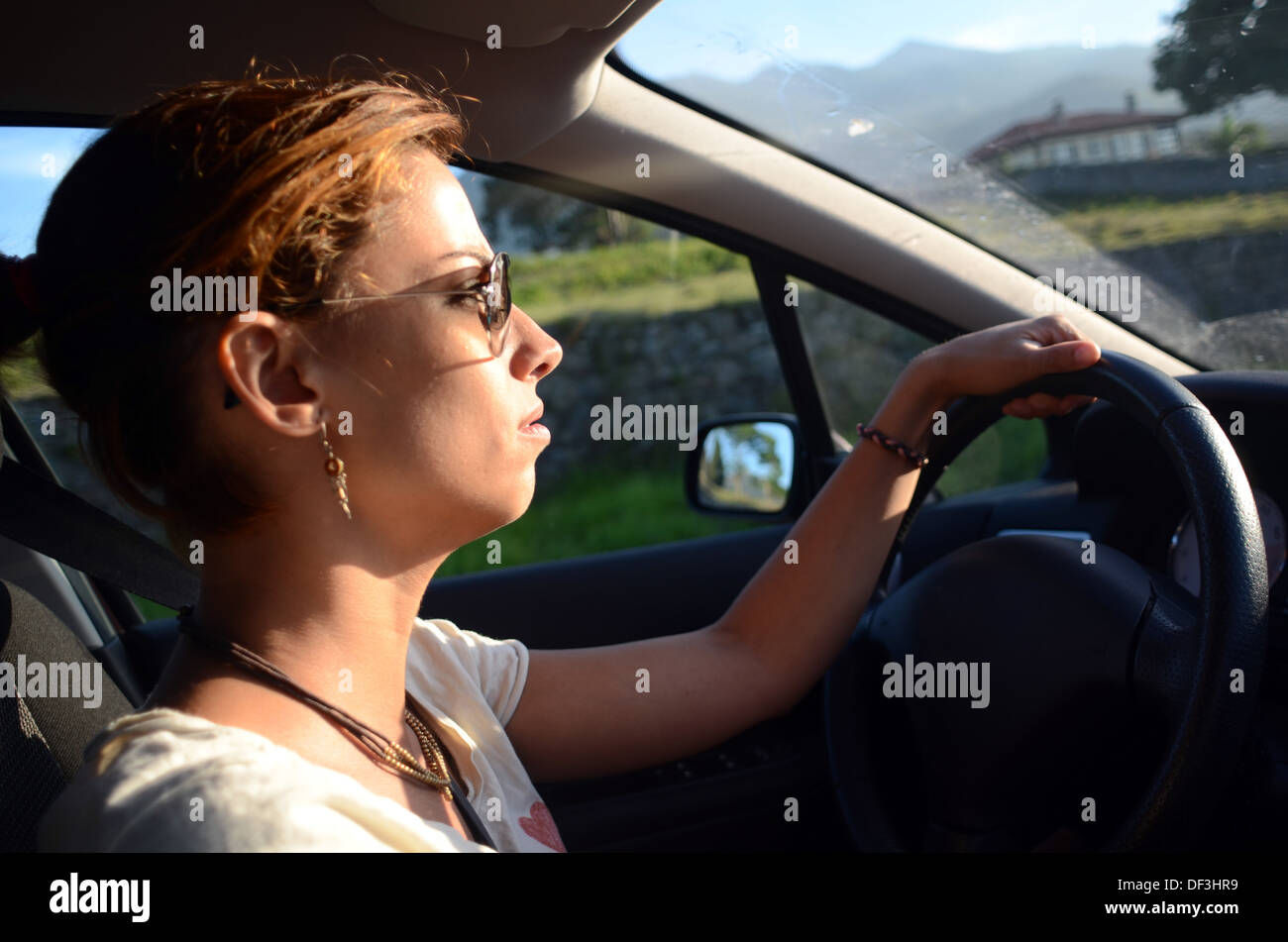Young woman driving her car Stock Photo - Alamy