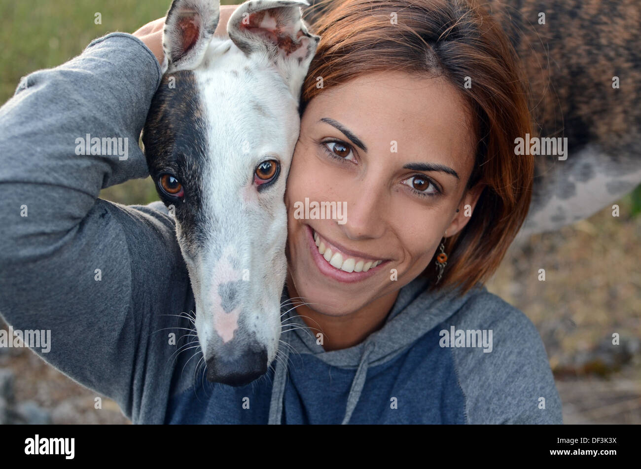 Attractive young woman poses with her greyhound dog Stock Photo - Alamy