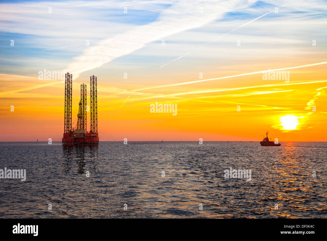 Oil rig at sunset background Stock Photo - Alamy