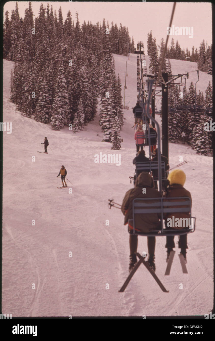 This photograph shows a chair lift transporting visitors to the top of ...