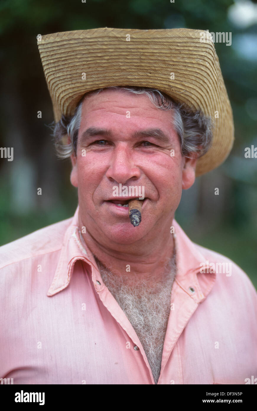 Cuba man with a pink face and wearing a pink shirt, smoking a cigar at ...