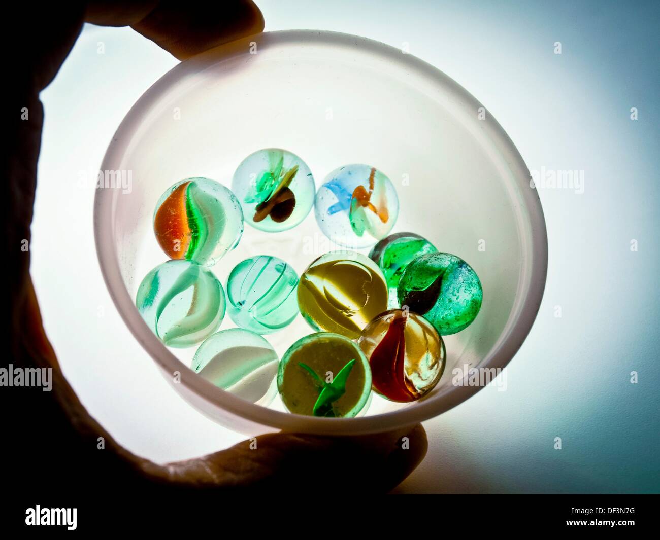 Hand holding marbles hi-res stock photography and images - Alamy