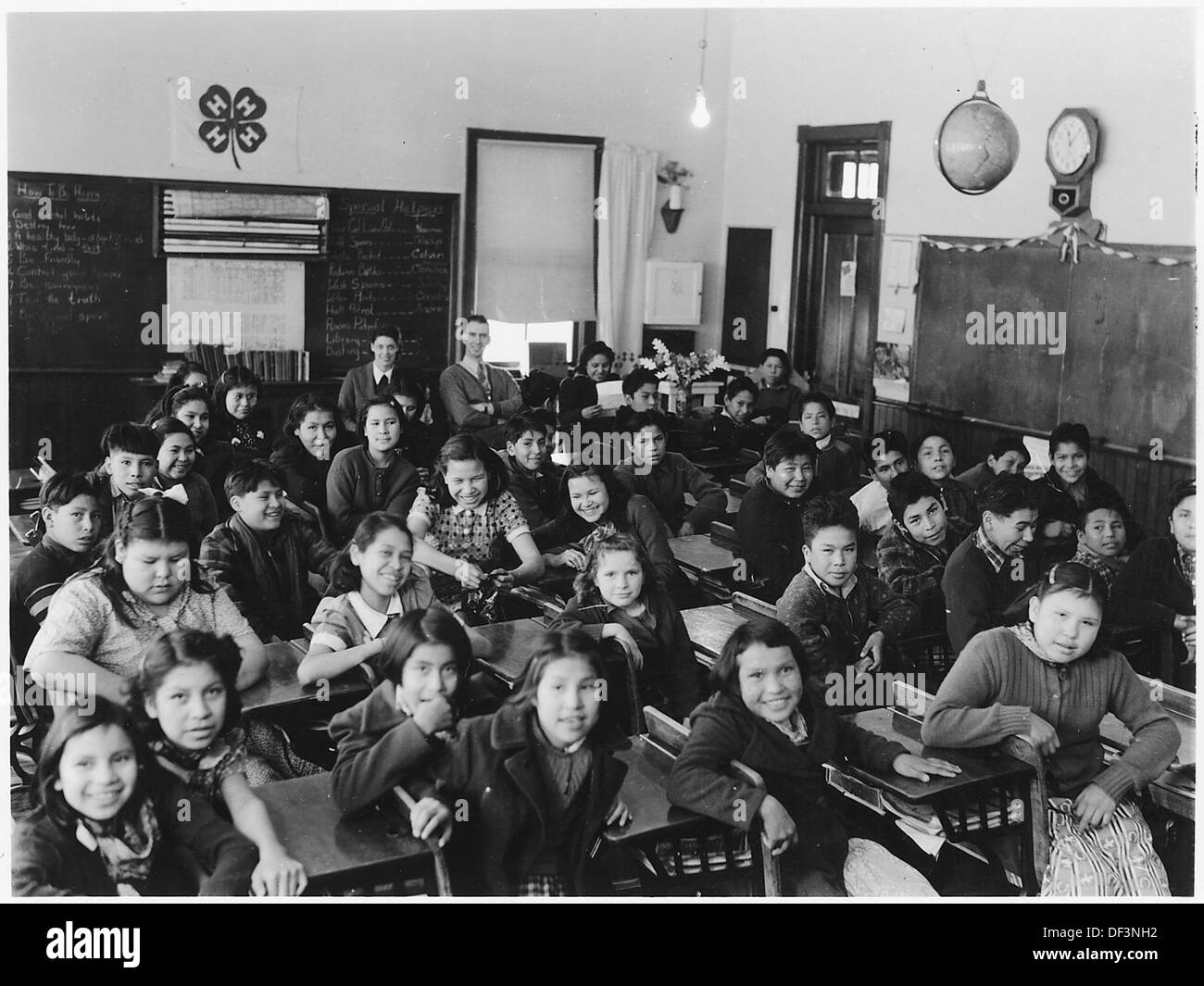 This photograph features a classroom with students and teachers ...