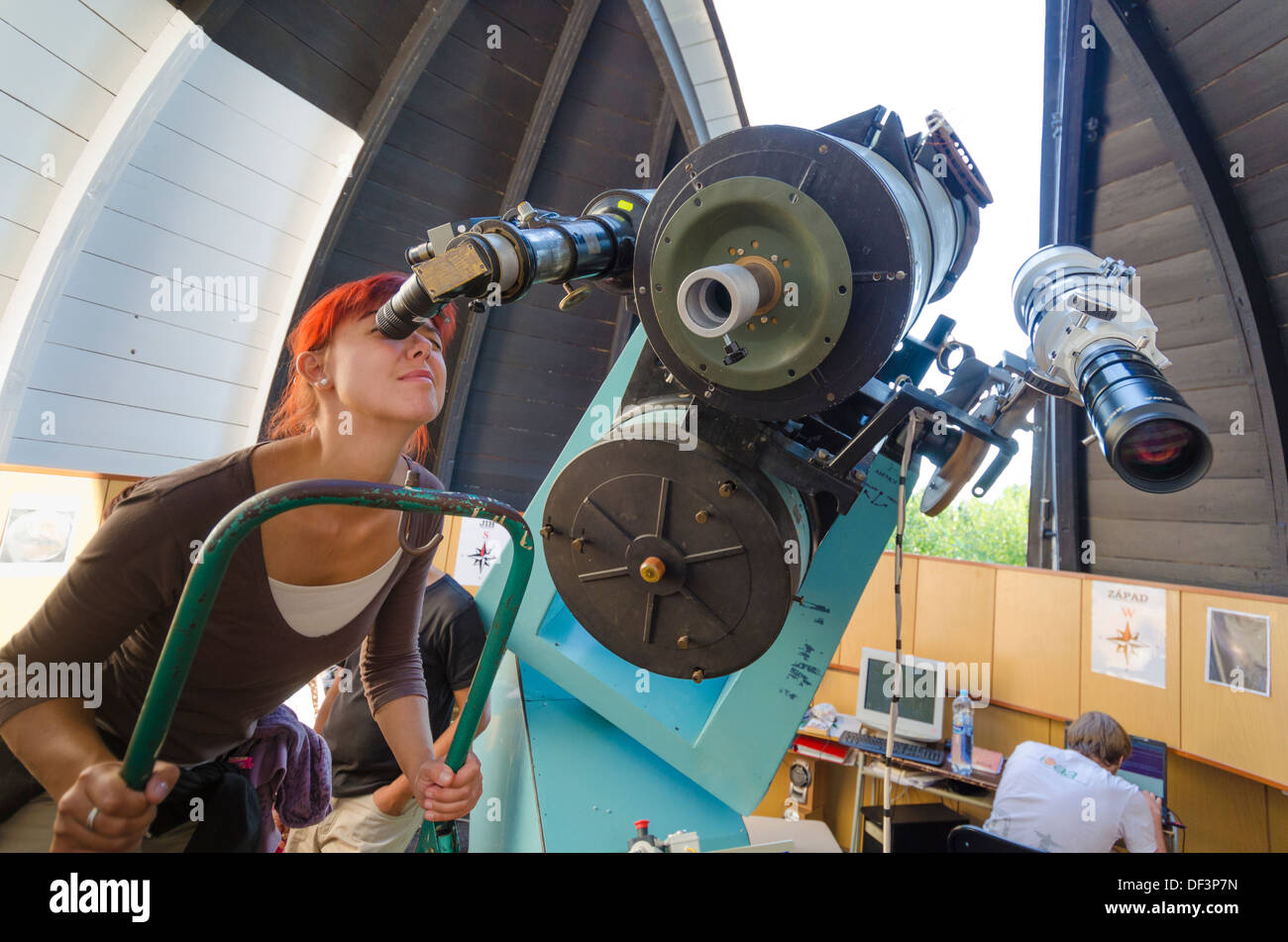 young girl looking through telescope, observing space objects Stock ...