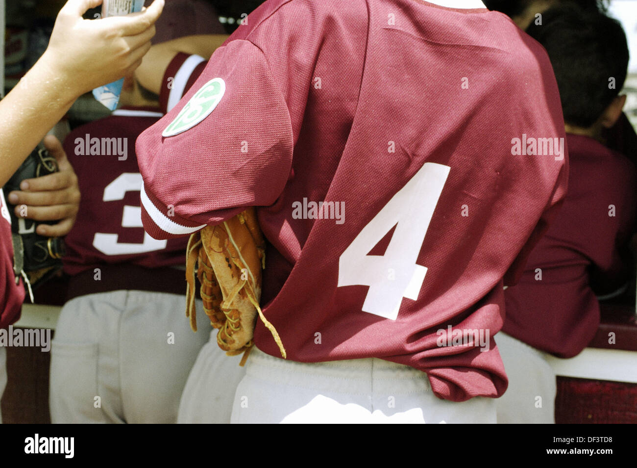 Baseball team gathering up, player number four Stock Photo - Alamy