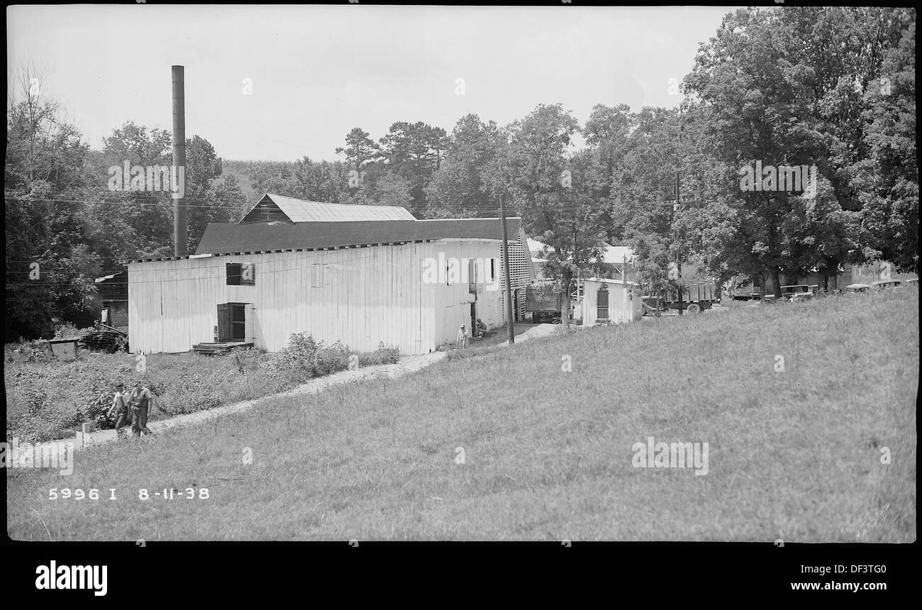 This photograph shows a corn packing plant, depicting the process of ...