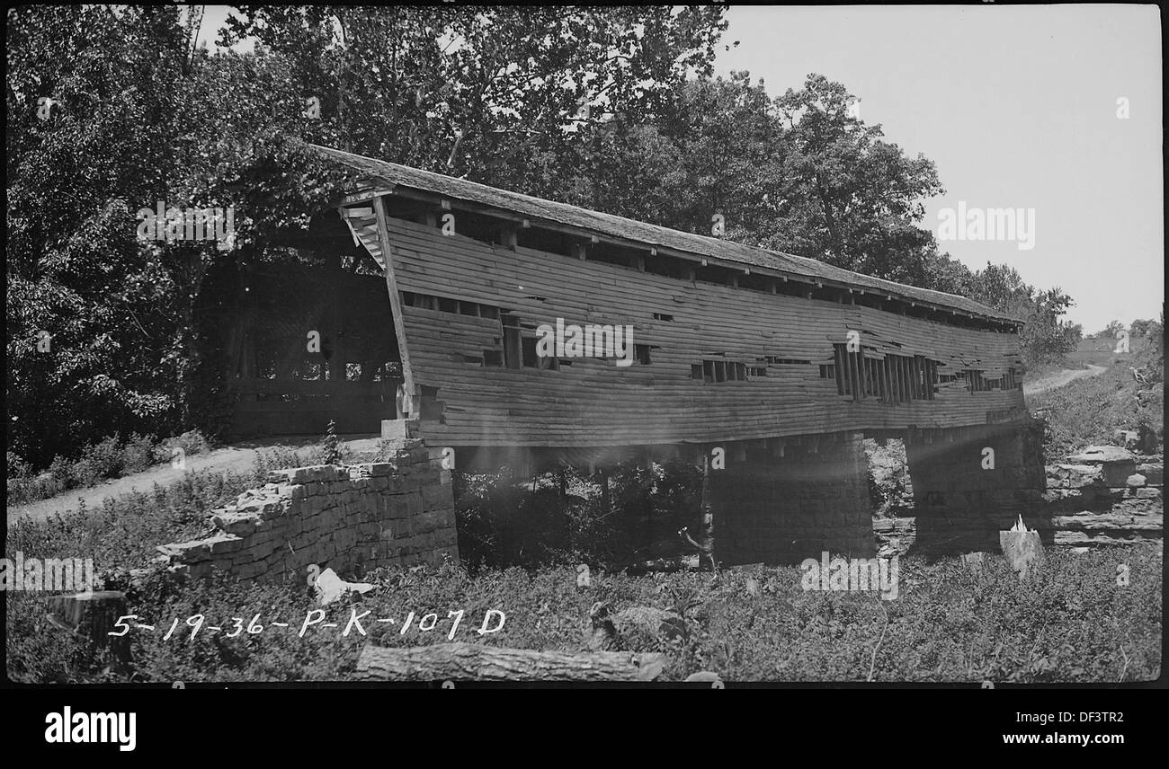 A historic covered bridge, captured in an old photograph. The bridge ...