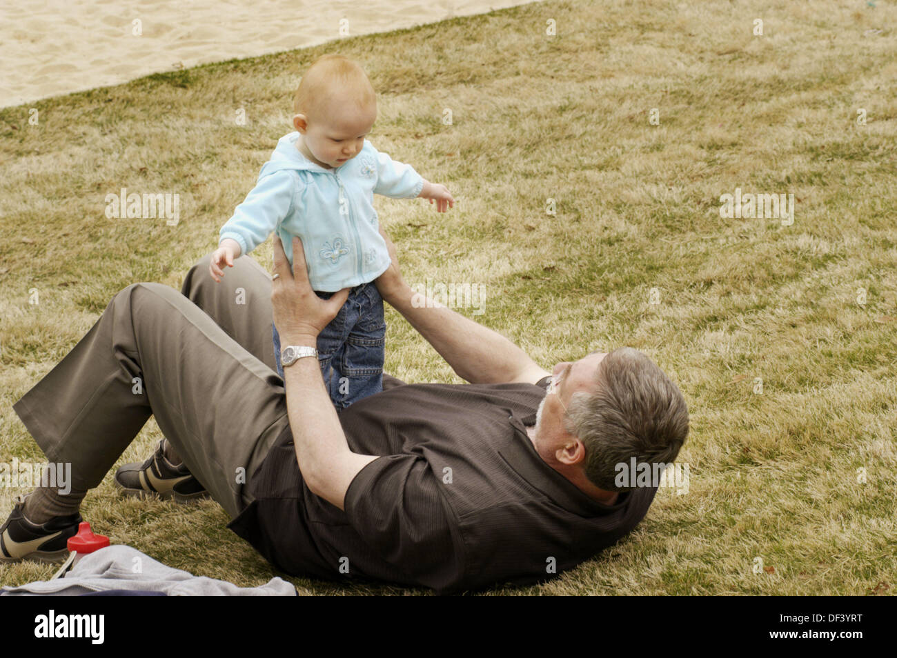 Family on the grass playing on nice day, dad and son Stock Photo - Alamy