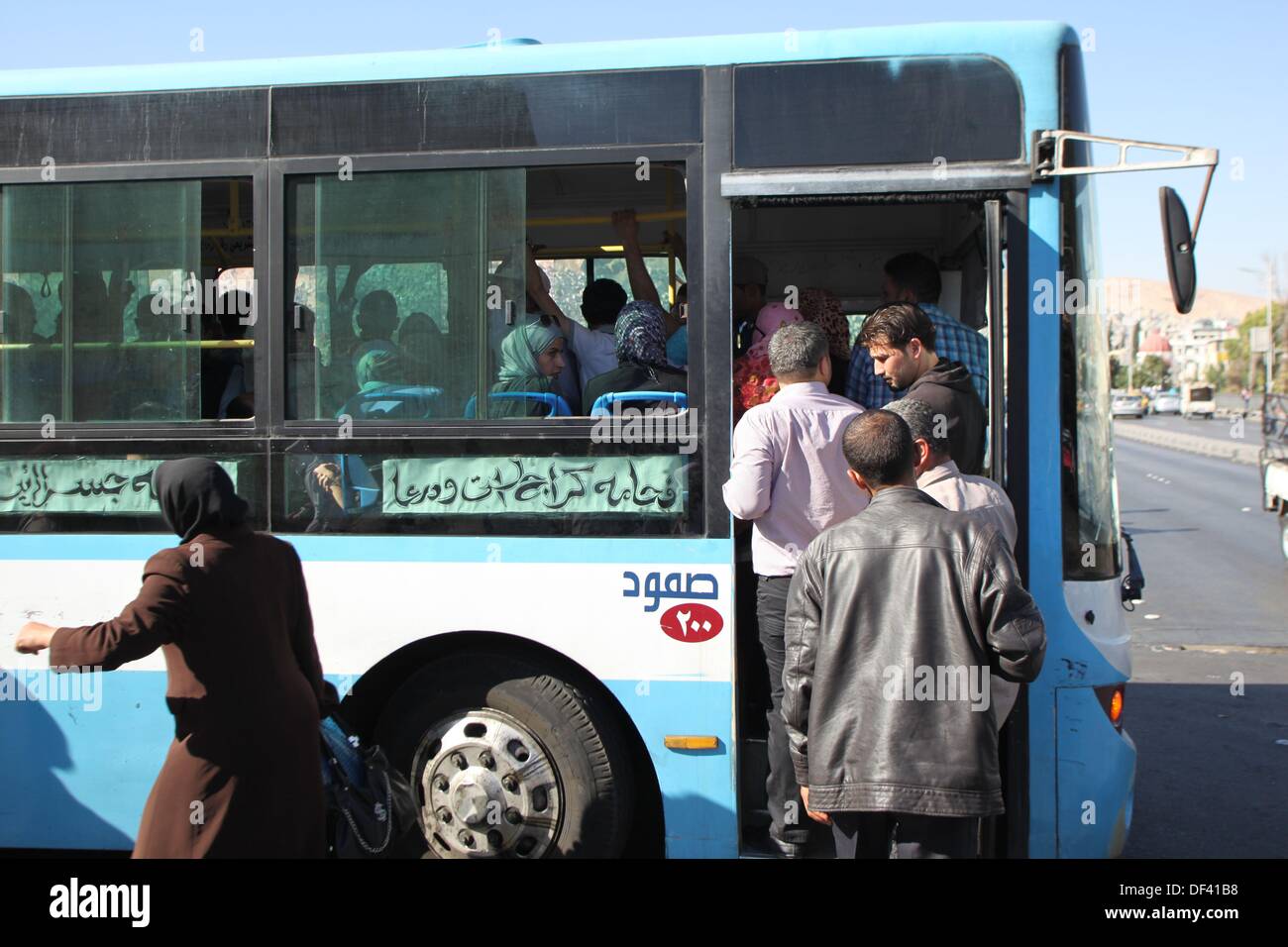 People enter a public bus in Damascus, Syria, on 2013-09-26. Photo ...