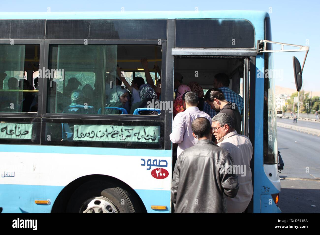 People enter a public bus in Damascus, Syria, on 2013-09-26. Photo ...