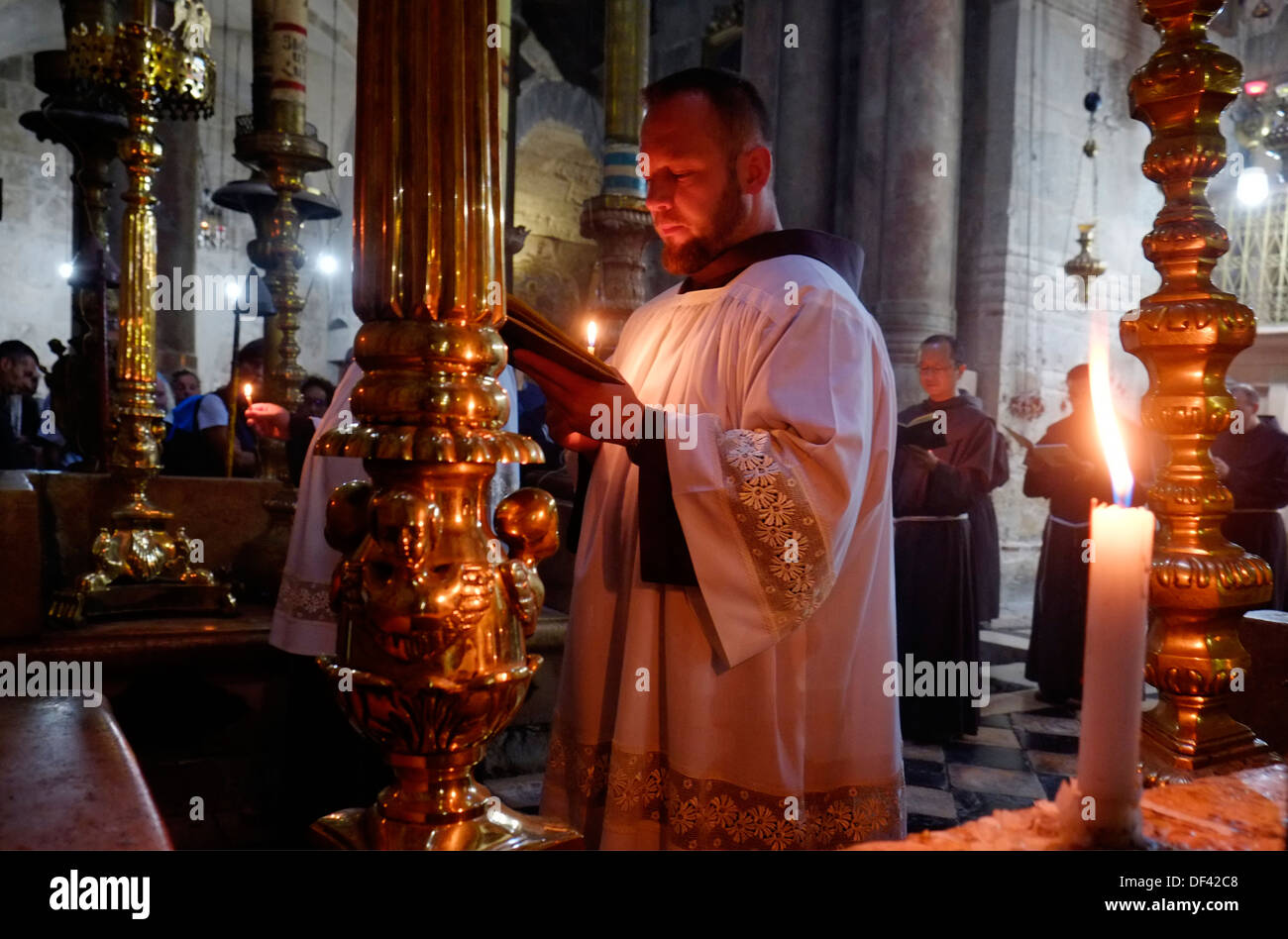Franciscan friars praying in Chapel of St. Helena inside the Church of ...