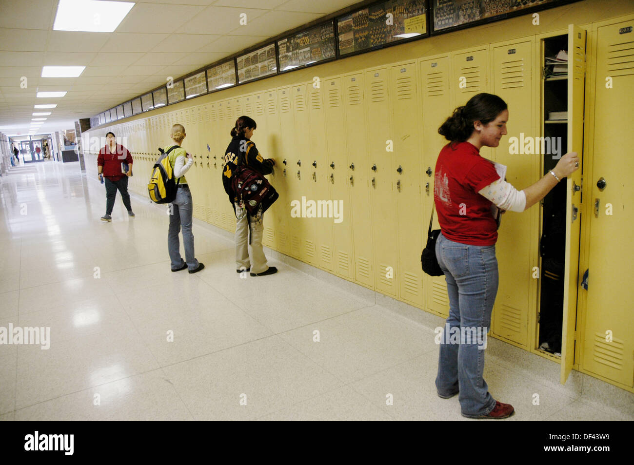 High school student opens combination lock on storage locker in a ...