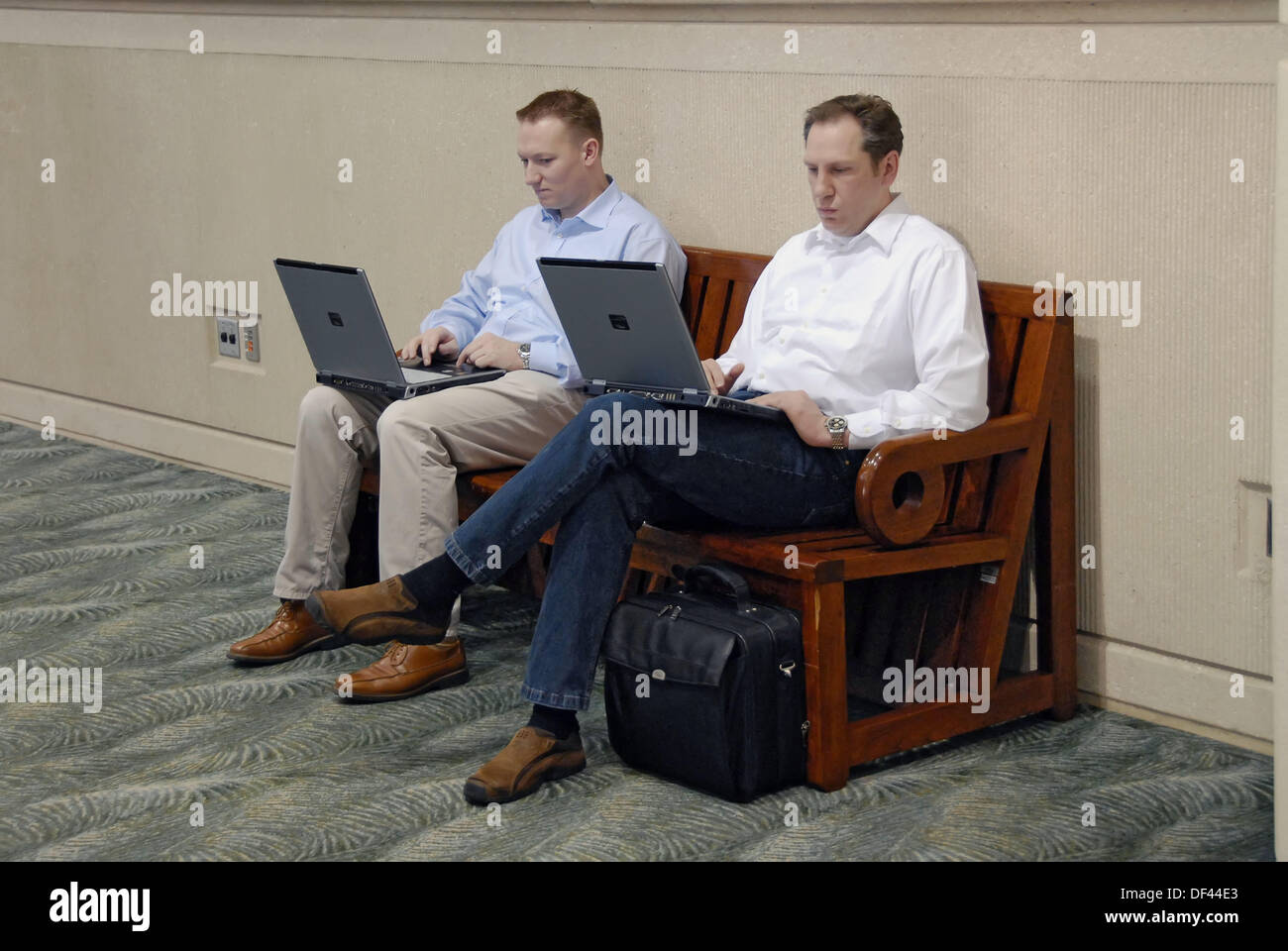 Adult businessman professional works on wireless laptop computer while ...