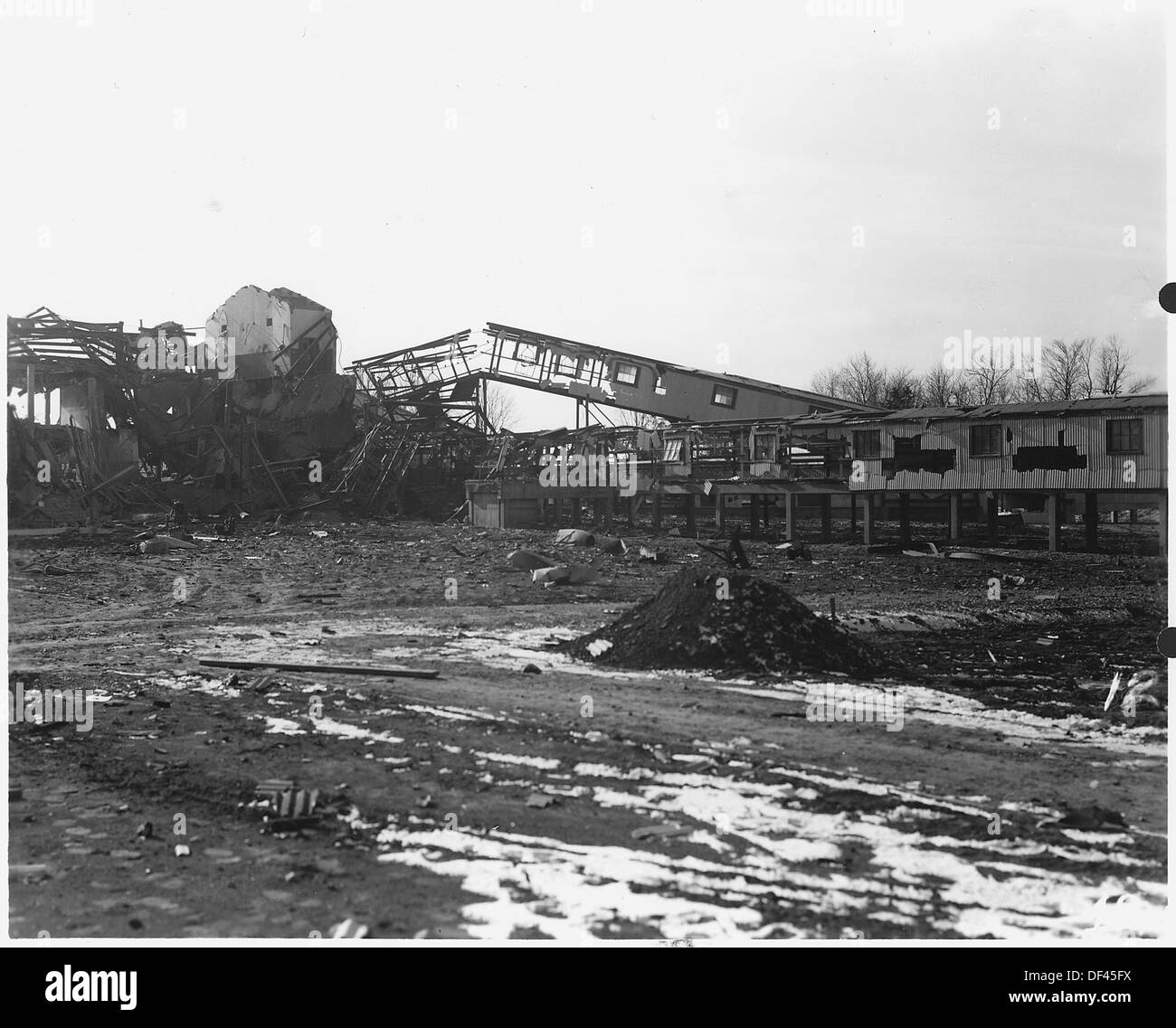The photograph shows explosion damage at the Iowa Ordnance Plant in ...