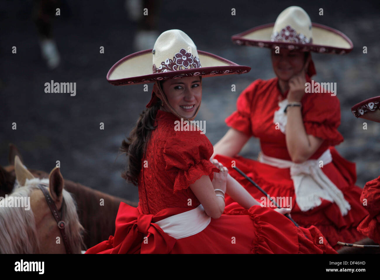 Two female amazon riders ride their horses during an escaramuza fair at ...