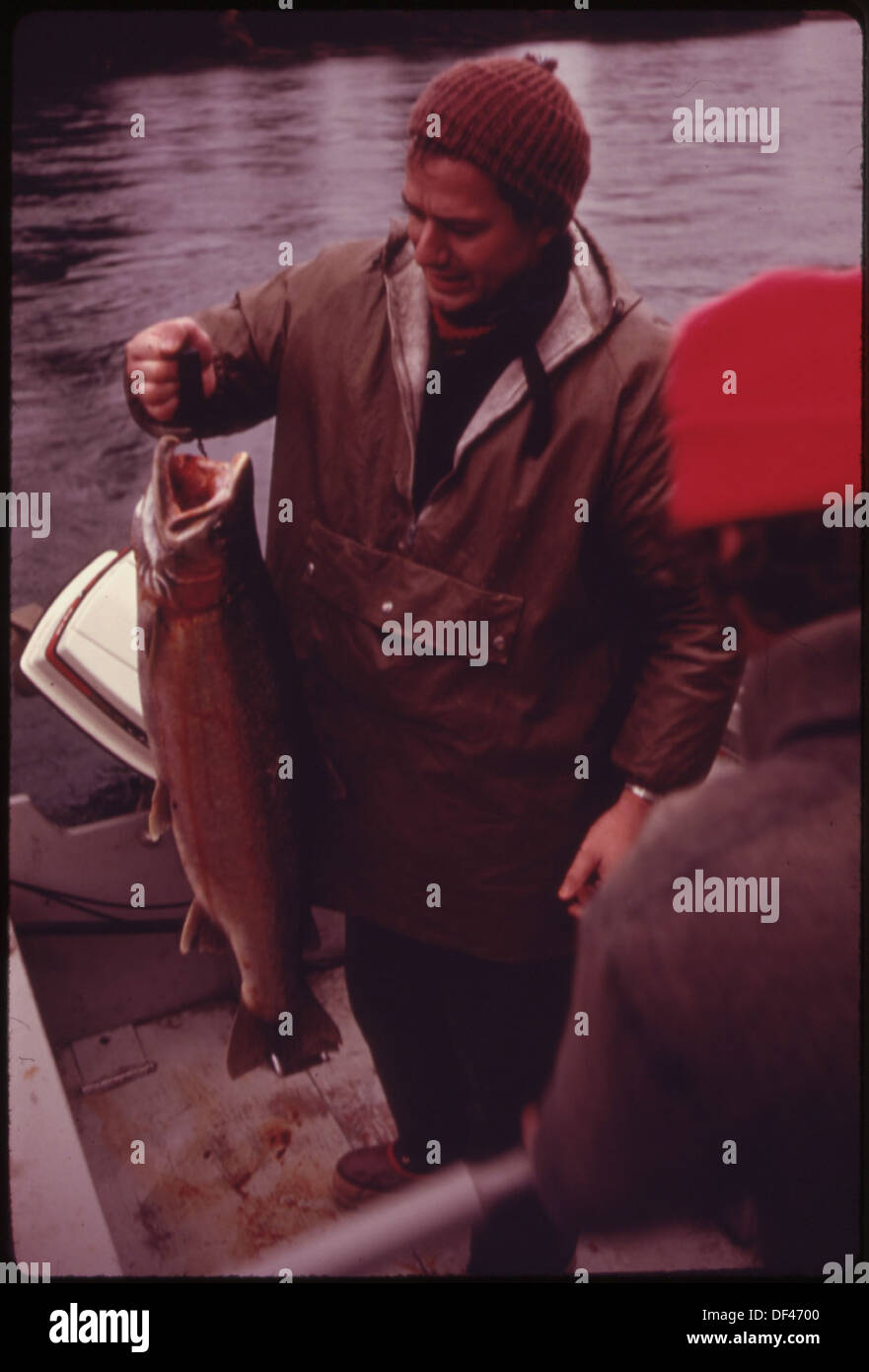 This image shows a fisherman displaying a large trout caught on the ...