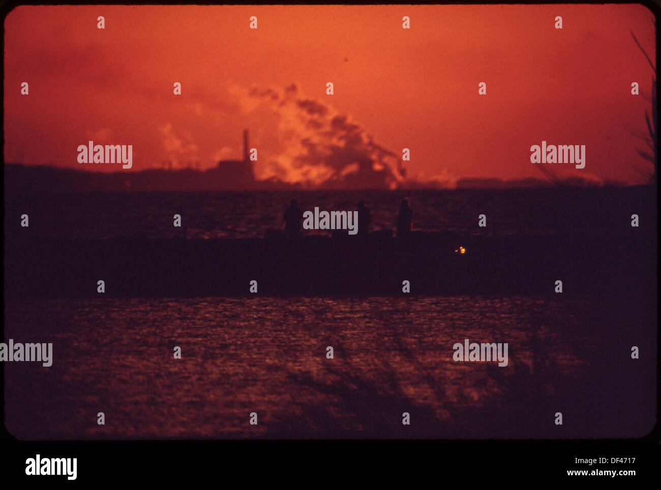 This image shows fishermen standing on a spit of land along the shore ...