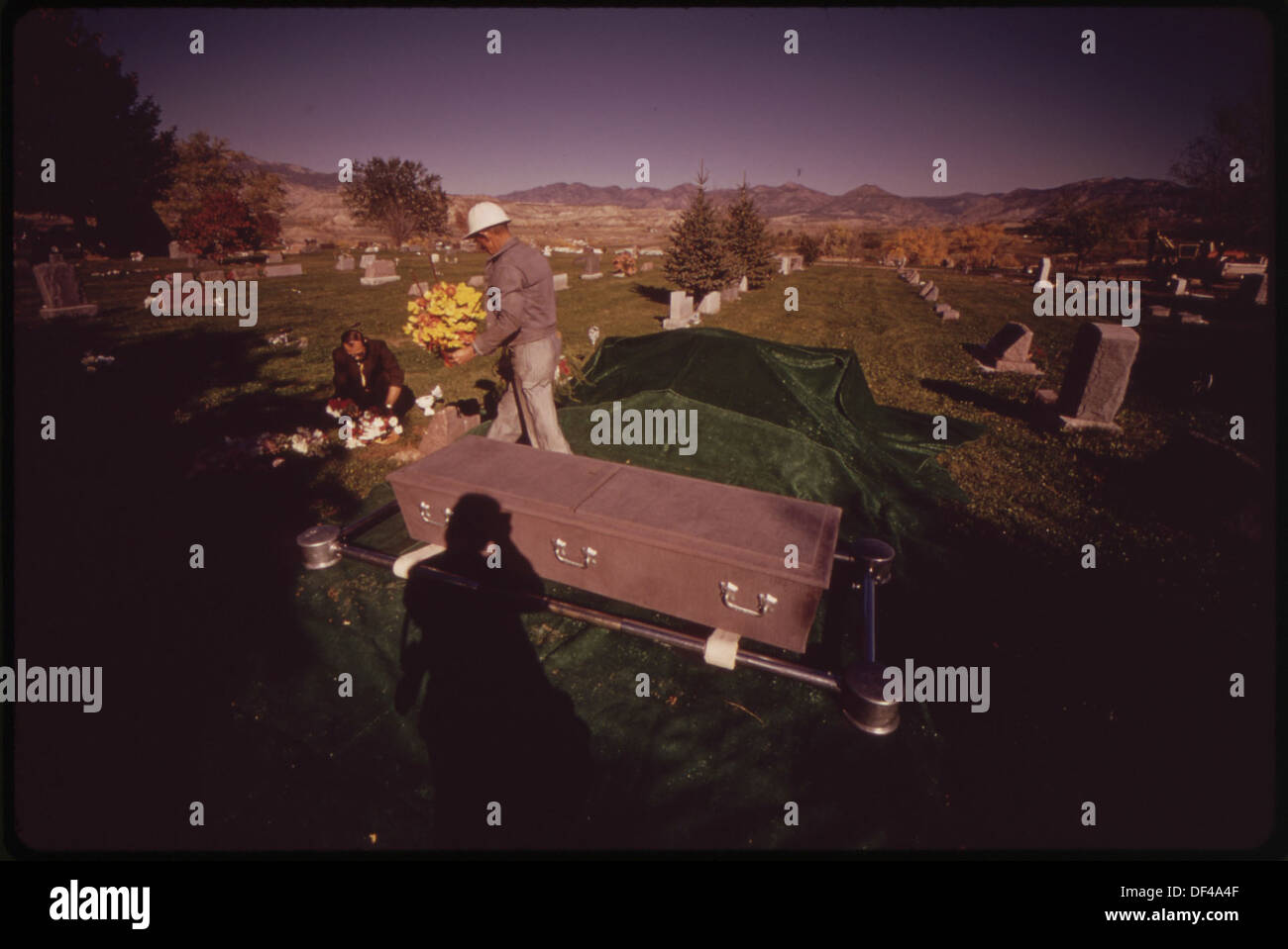 This historical photograph captures a funeral service at Rifle ...