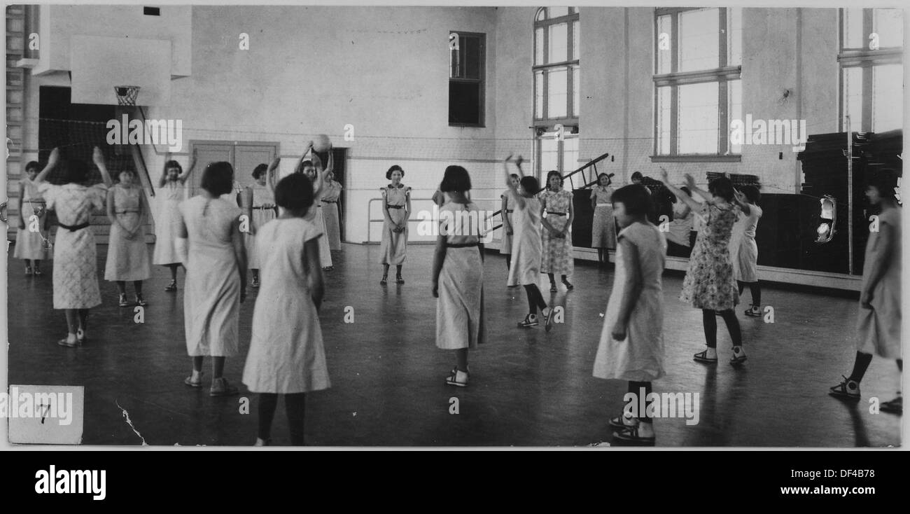 A historical photograph of a girls' gym class, depicting physical ...