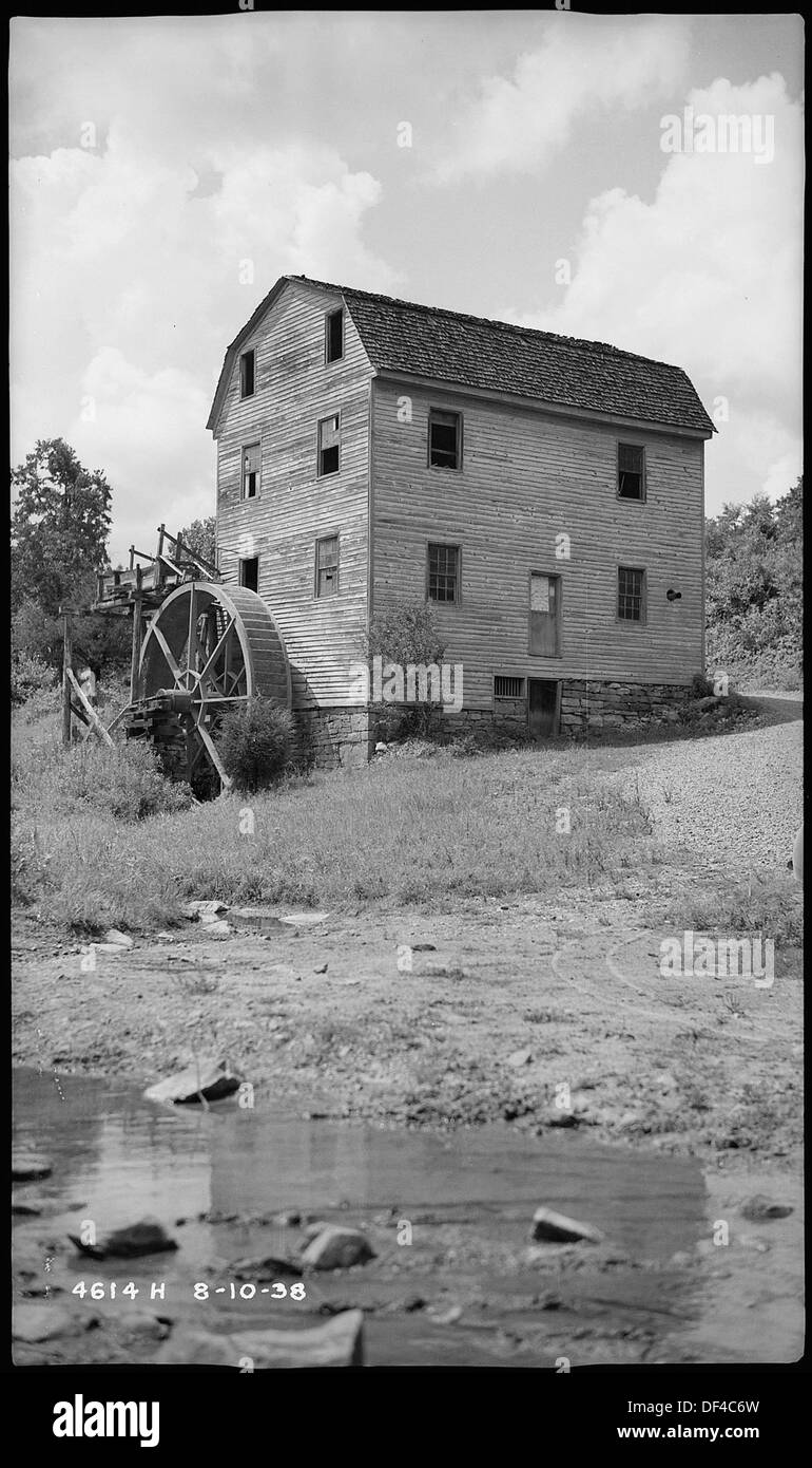 The image captures a historical grist mill, a structure used for ...