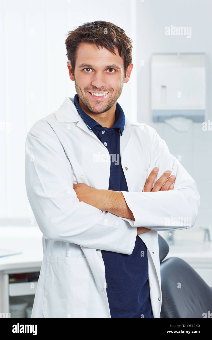 Smiling dentist with his arms crossed in his dental practice Stock ...