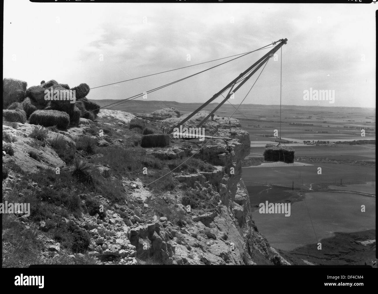 A photograph depicting a hand-operated winch, a piece of historical ...