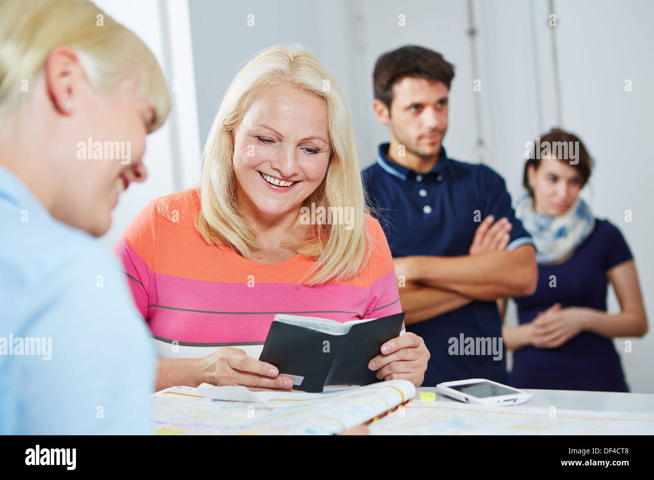 Smiling senior woman making appointment at doctors office at the ...