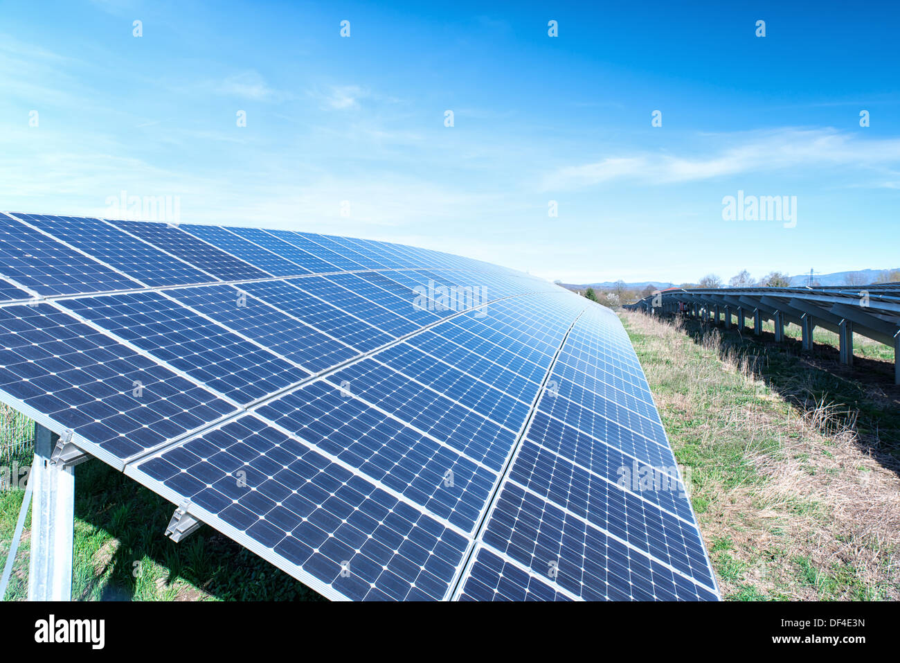Field with many solar cells in front of a blue sky Stock Photo - Alamy