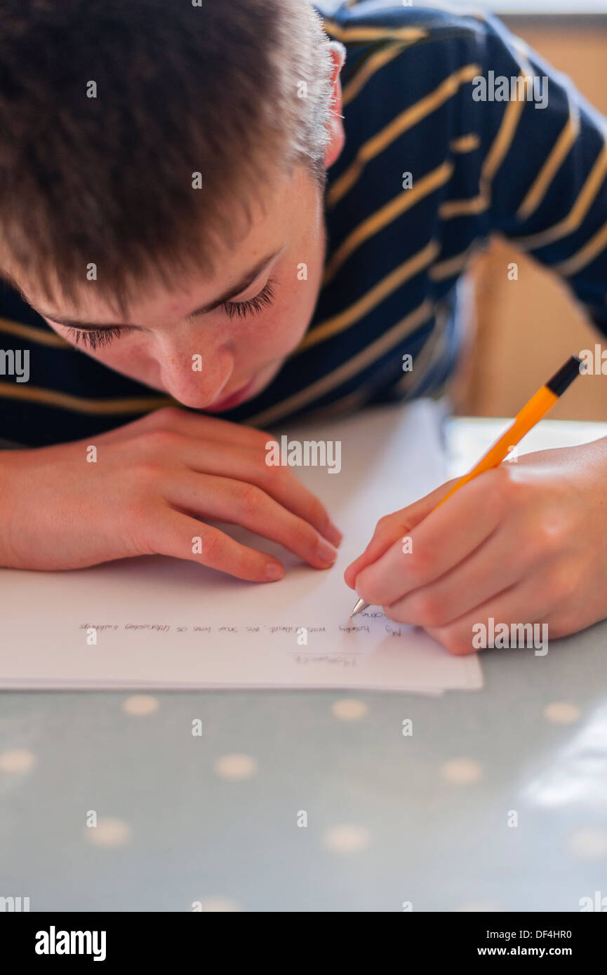 A 13 year old boy doing his homework in the kitchen Stock Photo - Alamy