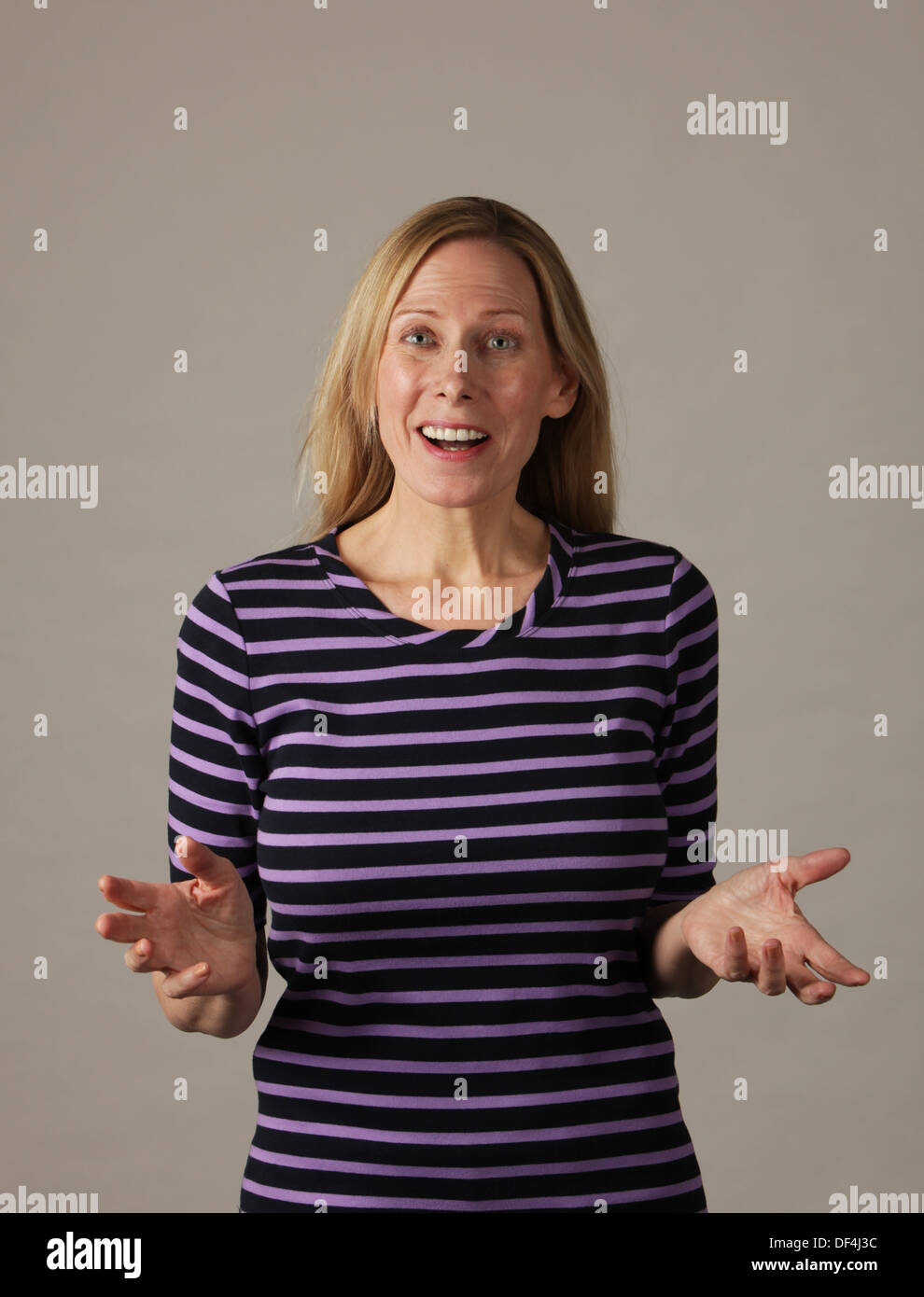 Surprised and excited attractive middle aged woman looking at camera ...