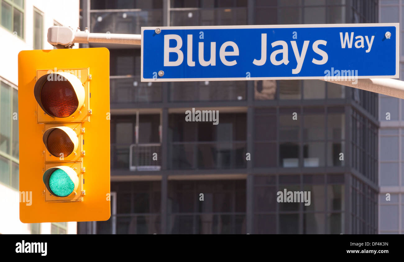 Blue Jays Way street sign with traffic light with green light Stock ...