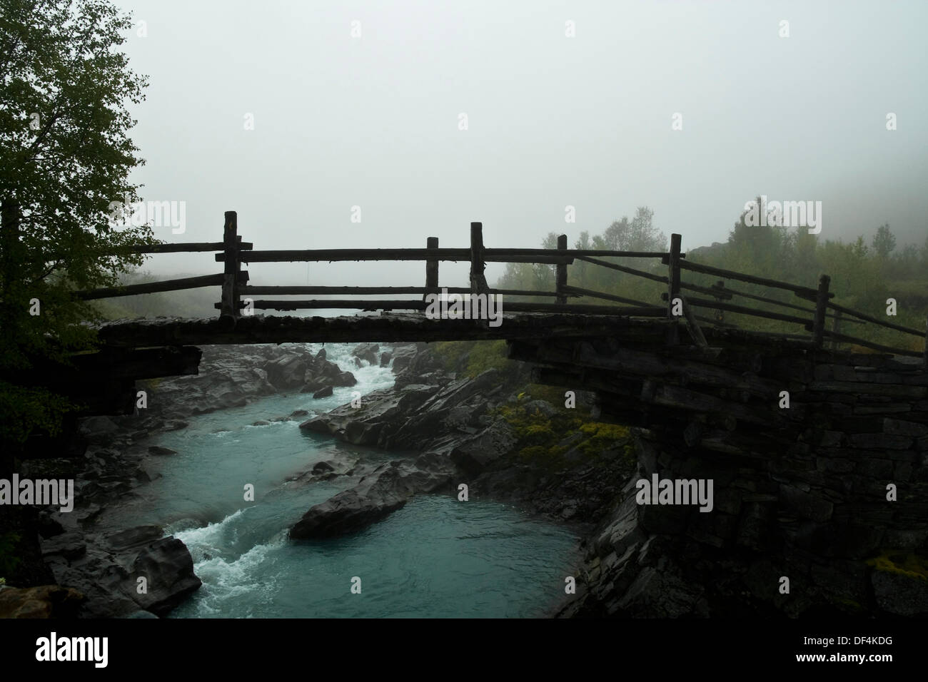 Rustic Footbridge over Rocky River on Foggy Day, Norway Stock Photo - Alamy