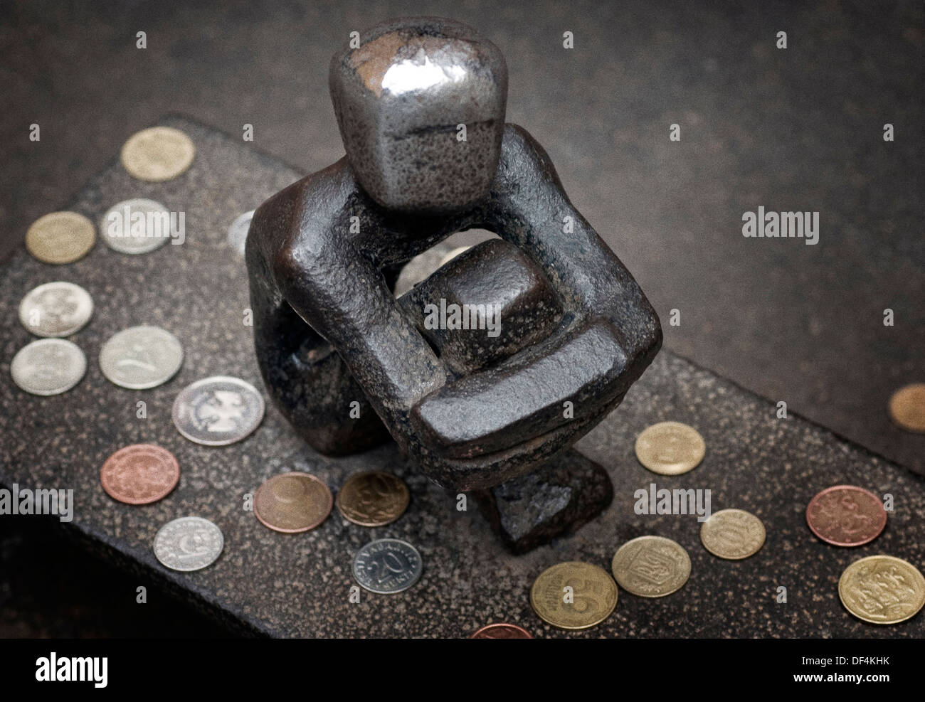 Sculpture of Beggar surrounded by Coins Stock Photo - Alamy
